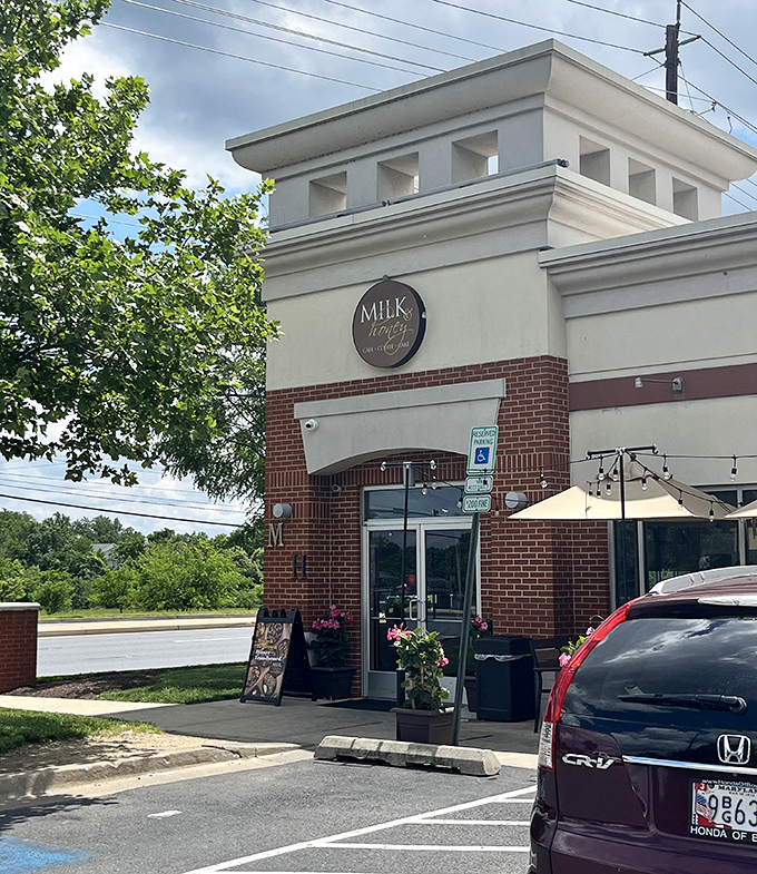 The brick-and-cream exterior of Milk & Honey stands like a beacon of brunch hope in College Park, promising Southern comfort in every bite.