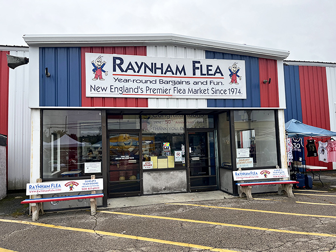 The red, white, and blue exterior of Raynham Flea Market stands like a patriotic beacon for treasure hunters. Where bargain-seeking becomes an Olympic sport.