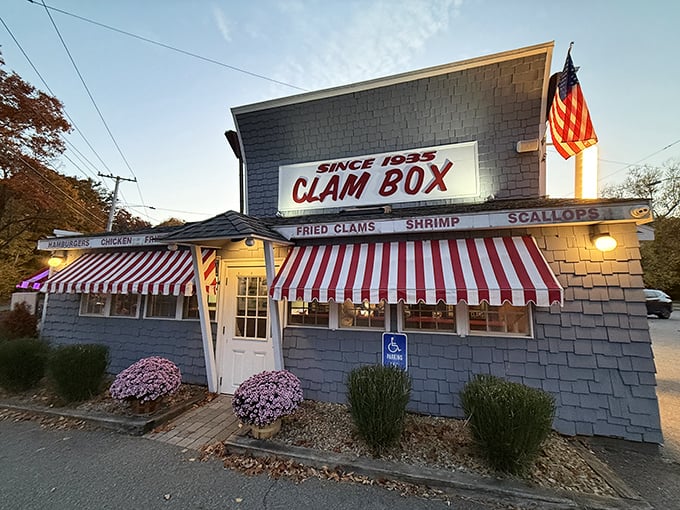 Bathed in golden evening light, the Clam Box's distinctive silhouette and red-striped awnings beckon seafood pilgrims like a lighthouse guiding hungry sailors home.