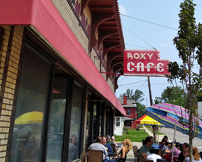The iconic red sign beckons hungry travelers like a breakfast lighthouse. Roxy Cafe's vintage charm stands defiant against the tide of chain restaurants.