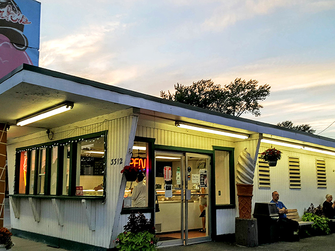The corner of nostalgia and deliciousness! Clark's iconic storefront glows at dusk, beckoning ice cream lovers with its vintage charm and promise of sweet relief.