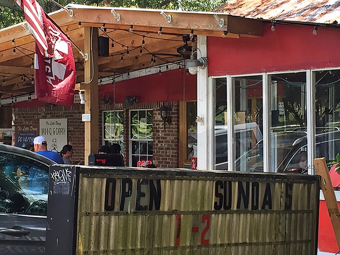 The weathered "OPEN SUNDAY" sign and rustic porch tell you everything &ndash; authentic BBQ doesn't need fancy advertising, just smoke signals.