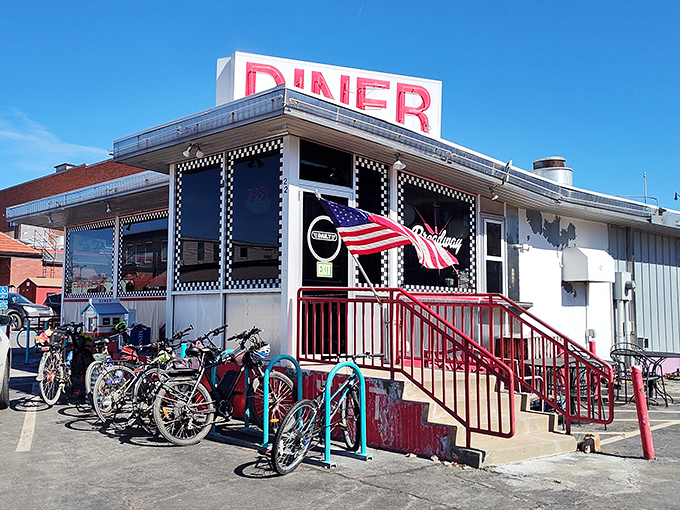 The classic red "DINER" sign beckons hungry travelers like a lighthouse for the breakfast-starved. Bicycles parked outside hint at local loyalty.