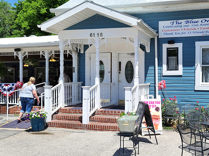 The Blue Owl's charming exterior welcomes you like an old friend, complete with white porch railings and flower baskets that whisper "come on in and stay awhile."