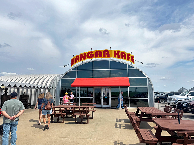 Not your average storefront&mdash;this aviation-themed eatery announces itself with bold red letters and rustic outdoor seating, perfect for plane-spotting between pancake bites.