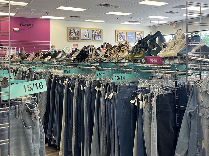 The denim paradise at Plato's Closet organizes jeans by size, creating a shopper's highway to fashion heaven without the usual thrift store treasure hunt.