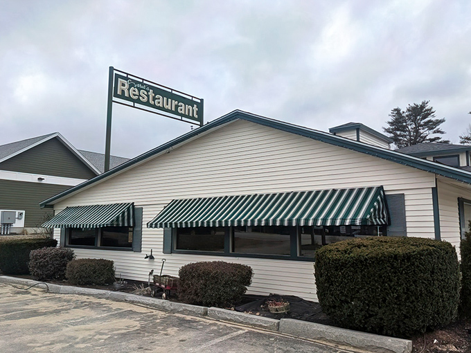 Green-and-white awnings frame windows like eyelashes on a building that's seen some delicious things.