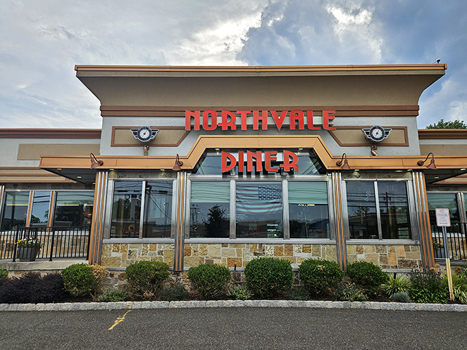 The gleaming red letters of Northvale Diner beckon like a lighthouse for the breakfast-starved. Classic architecture with modern touches promises comfort inside.