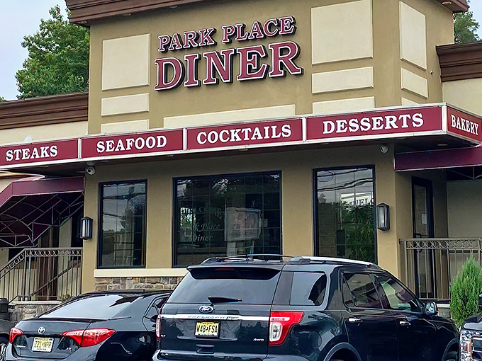 The iconic Park Place Diner sign glows like a beacon of breakfast hope against the New Jersey sky. Promises of steaks, seafood, and desserts that'll make your diet cry uncle.