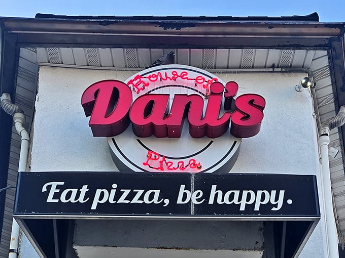 The neon sign says it all: "Eat pizza, be happy." Has there ever been a more perfect life philosophy etched in pink and white?