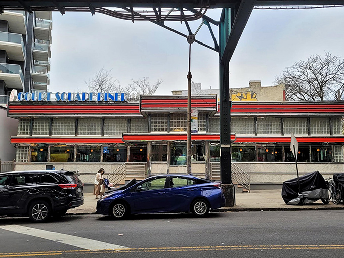 The morning glow of Court Square Diner welcomes early risers like a beacon for hungry souls. Classic Americana at its finest.