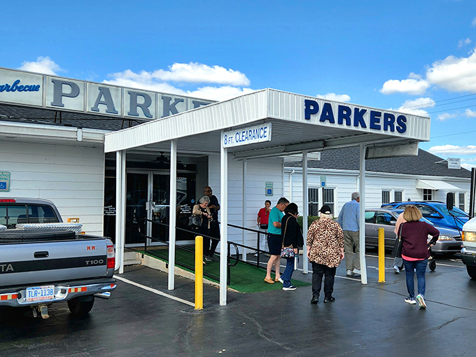 The iconic white exterior of Parker's Barbecue stands like a beacon for hungry travelers. That "8 FT CLEARANCE" sign isn't just a warning&mdash;it's a promise of headroom for big appetites.