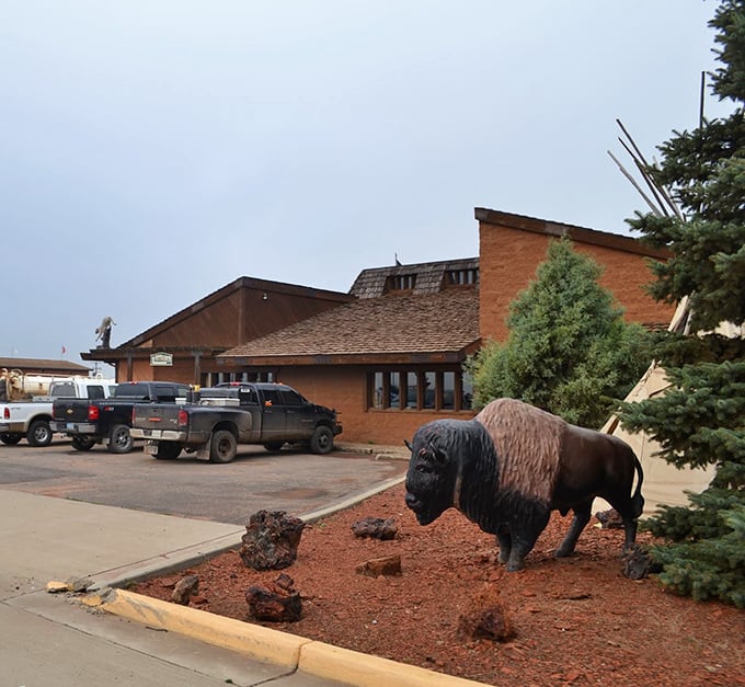 The iconic buffalo statue stands guard outside Trapper's Kettle, silently promising the hearty meal that awaits inside. North Dakota hospitality in sculptural form.