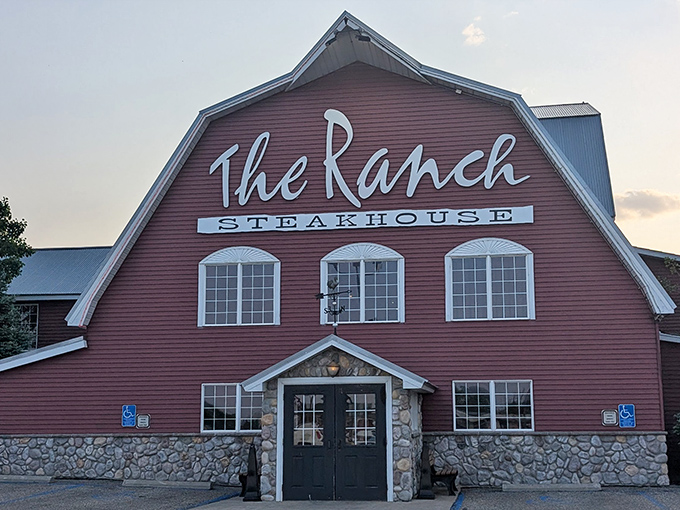 The iconic red barn exterior of The Ranch Steakhouse stands proudly against the North Dakota sky, beckoning hungry travelers with its rustic charm.