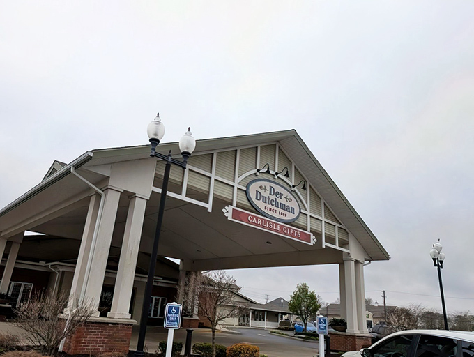 Der Dutchman's welcoming entrance stands like a culinary lighthouse, beckoning hungry travelers with promises of Amish comfort food that'll make your cardiologist wince and your soul sing.