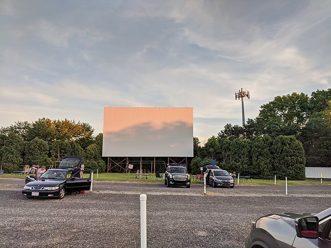 The golden hour at Elm Road Triple Drive-In transforms an ordinary parking lot into a cathedral of nostalgia, where memories are made under open skies.