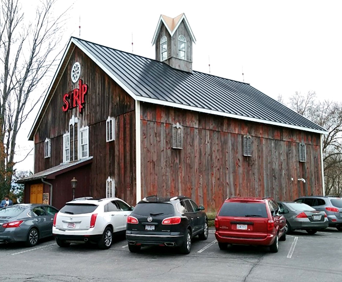 The weathered barn exterior of Strip Steakhouse stands as a delicious contradiction&mdash;rustic farmhouse on the outside, culinary paradise within.