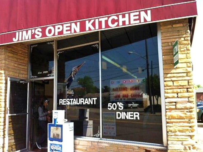 That classic red awning and stone facade scream "authentic diner experience" before you even taste the first bite.