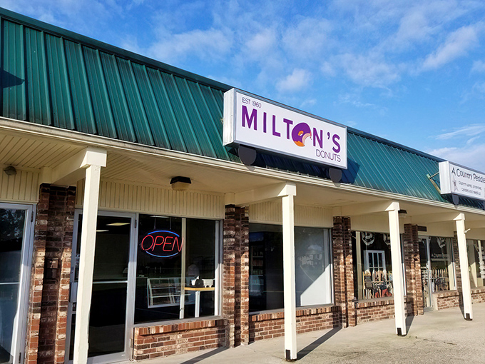Milton's unassuming storefront stands like a beacon of hope for donut lovers, its green roof and simple brick facade hiding sugary treasures within.