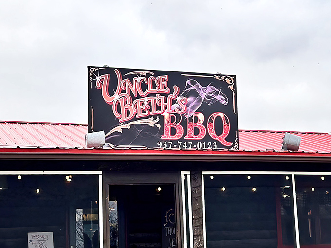 The bright red roof and bold signage of Uncle Beth's BBQ stands out like a beacon for hungry travelers. Meat salvation awaits within. 