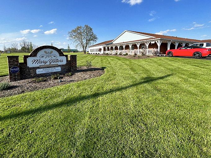 That green lawn and welcoming sign announce you've arrived somewhere special, where buggies meet bumpers in peaceful coexistence.