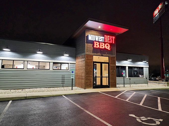 The neon glow of Midwest Best BBQ beckons like a barbecue lighthouse in the night, promising smoky treasures within those unassuming walls.