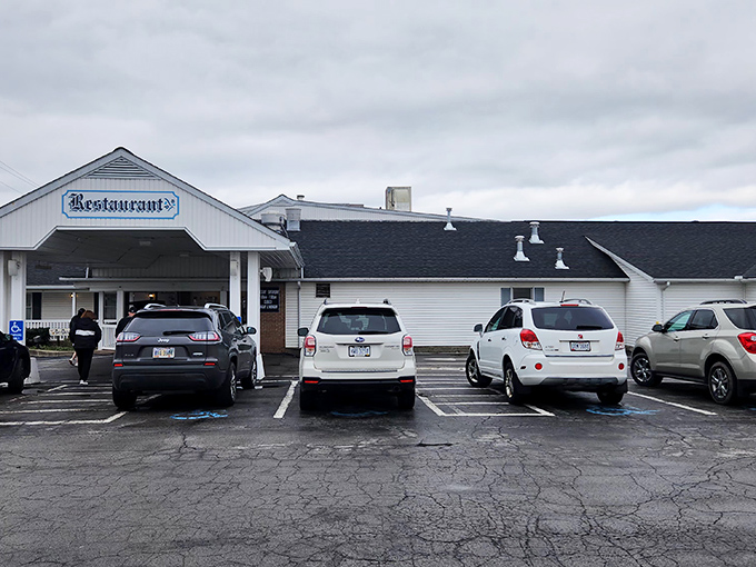 The classic Amish buggy amid vibrant pink flowers welcomes visitors to Das Dutch Haus, a charming first impression that promises authentic traditions inside.