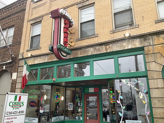 The iconic green-trimmed storefront of Corbo's Bakery stands as a beacon of sweetness in Cleveland's Little Italy, promising Italian delights within.