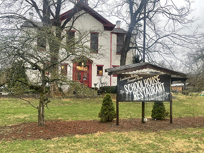 The historic white schoolhouse with its distinctive red trim stands proudly among the trees, promising lessons in comfort food that'll make you want to raise your hand for seconds.
