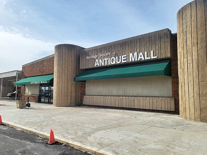 The unassuming exterior of Heritage Square Antique Mall stands like a time portal in Reynoldsburg, quietly promising treasures that your grandkids will fight over someday.