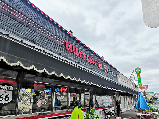 The neon-lit promise of Route 66 nostalgia beckons hungry travelers. Tally's exterior is like a time machine disguised as a diner.