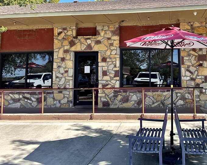 A classic Oklahoma welcome: rustic stone walls, a shady porch, and the promise of barbecue that'll make you question why you ever bothered with a knife and fork.
