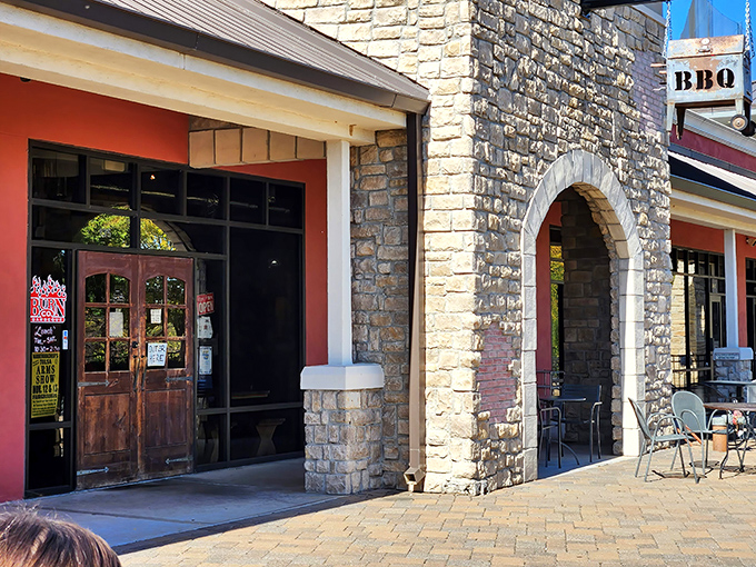 The stone archway entrance to Burn Co isn't just inviting—it's practically a portal to the promised land of perfect brisket. Welcome to BBQ heaven.