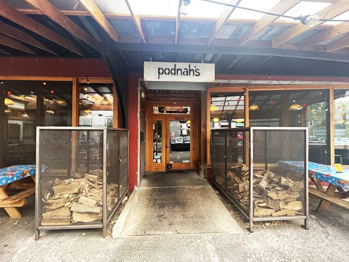 The entrance to barbecue paradise. Those wood stacks flanking the door aren't decorative &ndash; they're the secret behind that intoxicating smoky aroma that greets you.