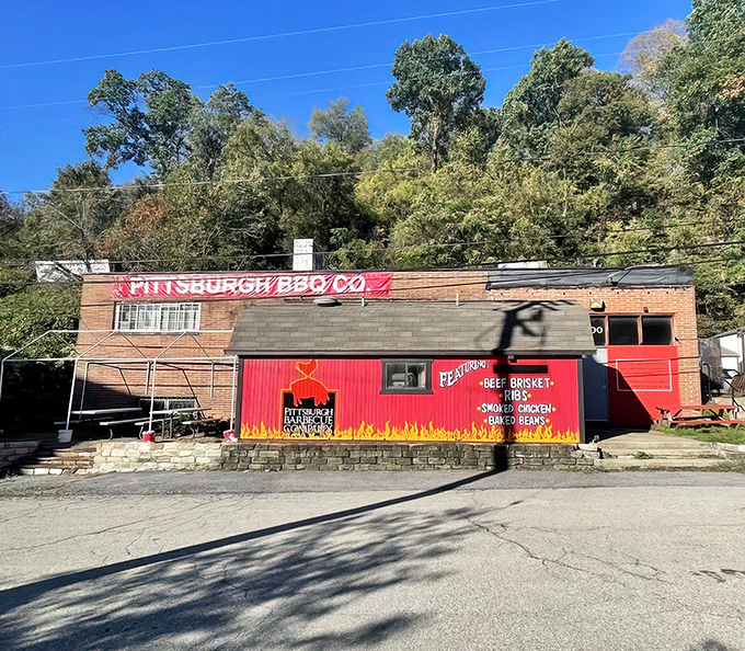 The bright red facade of Pittsburgh Barbecue Company stands out like a beacon of smoky promise against the Pennsylvania hillside. No fancy frills needed when the food does all the talking.