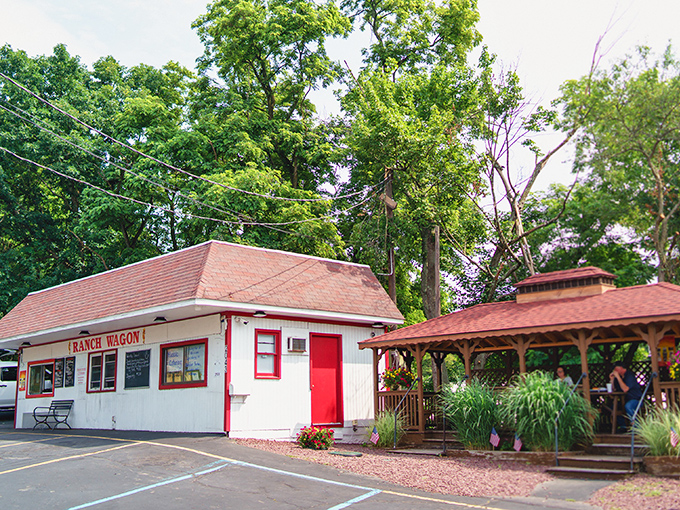 The humble white building with red trim might not look like much, but this unassuming roadside spot houses hot dog magic that locals have treasured for generations.