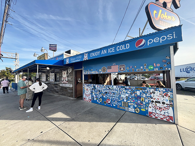 The iconic cartoon pig sign stands proudly above John's Roast Pork, a blue sandwich sanctuary that's been calling Philadelphians home since 1930.