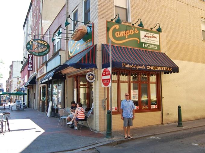Campo's iconic blue awning and vintage sign stand as a beacon for cheesesteak pilgrims in Old City Philadelphia, promising authentic flavors just steps from Independence Hall.
