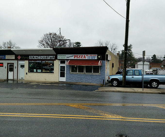 The unassuming blue-bricked storefront of Imperial Pizza stands as a testament that culinary treasures often hide in plain sight.