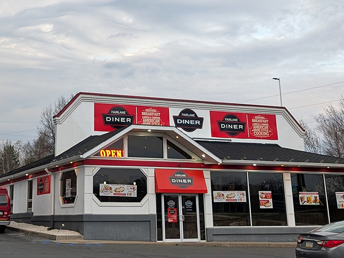 The red and white exterior of Fairlane Diner stands like a beacon of breakfast hope. Classic American diner architecture promising comfort food that'll make your cardiologist wince but your soul sing.
