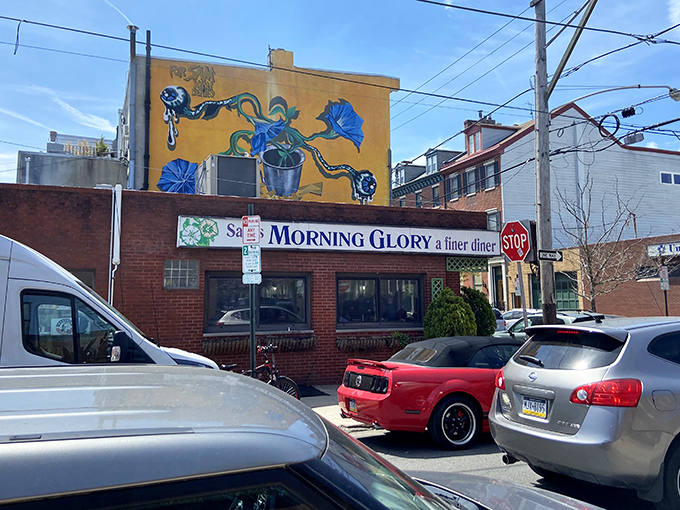 The iconic yellow mural and brick facade of Morning Glory Diner stands as a beacon of breakfast hope in Philadelphia's Bella Vista neighborhood.