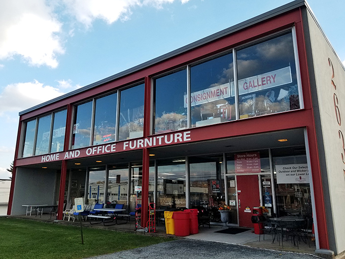 The iconic red-trimmed building stands out like a fashionable lady in a sea of beige, beckoning treasure hunters with promises of undiscovered gems inside.