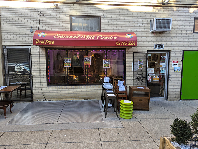 That burgundy awning welcomes bargain hunters like a lighthouse beacon guiding treasure seekers to thrift store paradise.