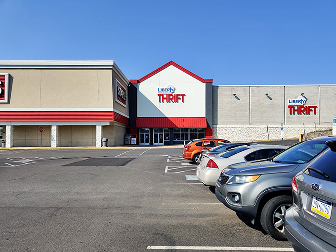The distinctive red-trimmed facade of Liberty Ministries Thrift stands like a beacon of bargain possibilities under Pennsylvania's blue skies.