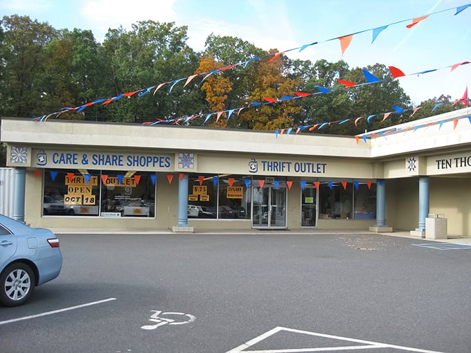 Festive bunting and bright blue skies welcome treasure hunters to Care & Share Thrift Shoppes, where bargain adventures begin beneath those cheerful flags.