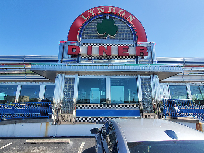 The gleaming stainless steel exterior of Lyndon Diner stands like a time capsule of Americana, complete with that iconic shamrock logo promising good luck and great food.