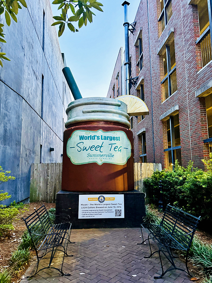 The World's Largest Sweet Tea stands proudly between brick buildings, complete with oversized straw and lemon slice&mdash;Southern hospitality supersized to Guinness-worthy proportions. 