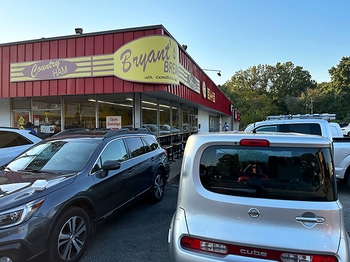 The iconic red exterior of Bryant's Breakfast stands out as a welcoming sight for hungry Memphians, with cars parked out front hinting at the popular breakfast waiting inside.