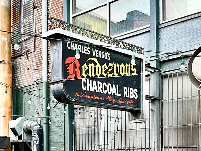 The iconic sign beckons from the alley like a smoky siren call &ndash; "Charles Vergos' Rendezvous" &ndash; promising charcoal ribs that have lured barbecue pilgrims since 1948.
