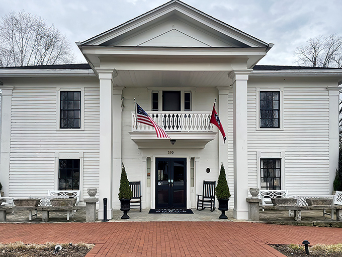 The grand white colonial facade of Miss Mary Bobo's stands like a Southern sentinel, complete with rocking chairs that practically whisper "sit a spell."